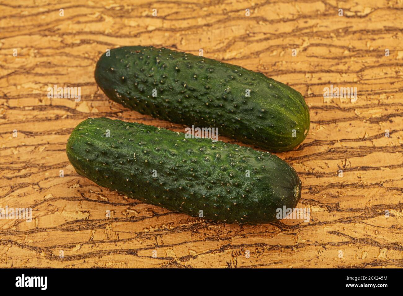 Green fresh two cucumbers over background Stock Photo - Alamy