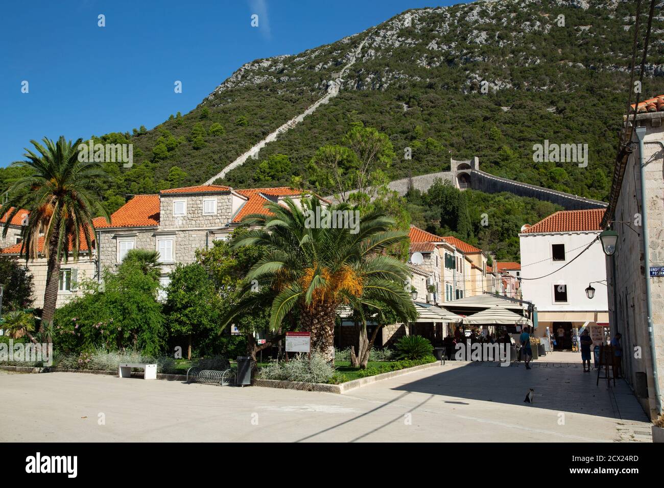 Medieval town square with mountain walls in the background Stock Photo ...