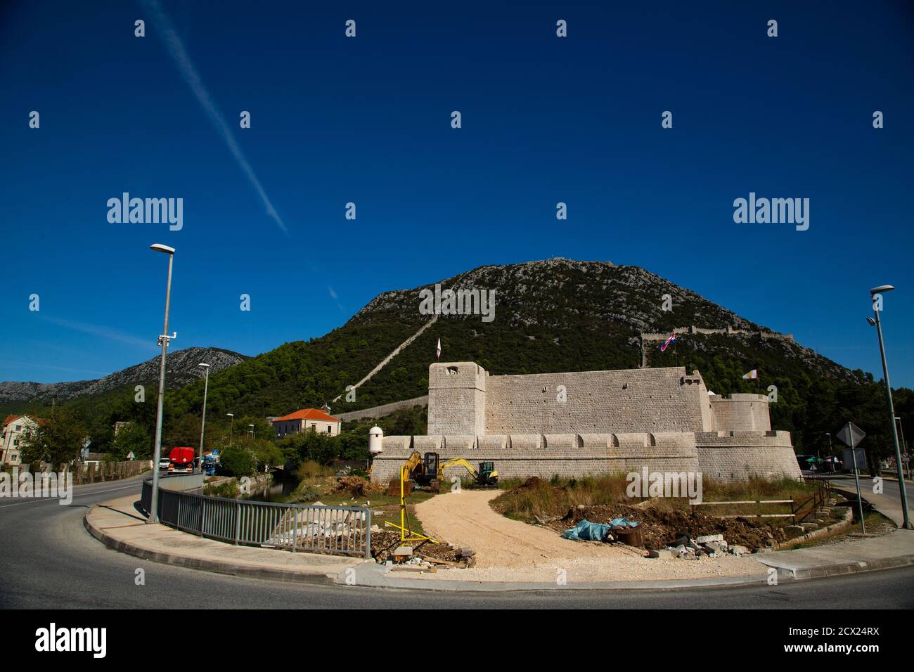 Medieval fortification from road with mountain in the background Stock ...