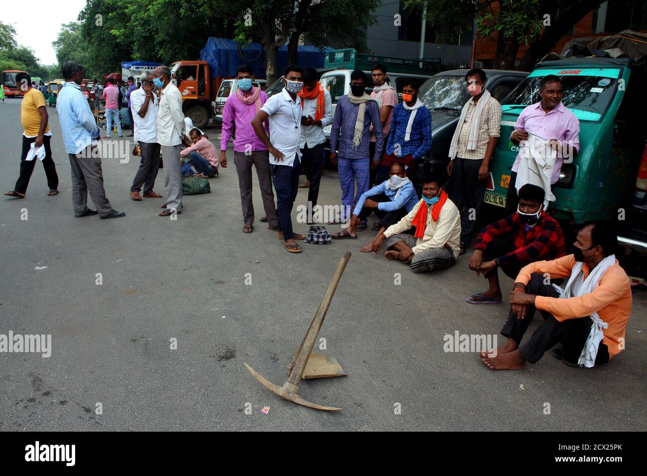 Group of construction worker sitting on road waiting for work Stock ...