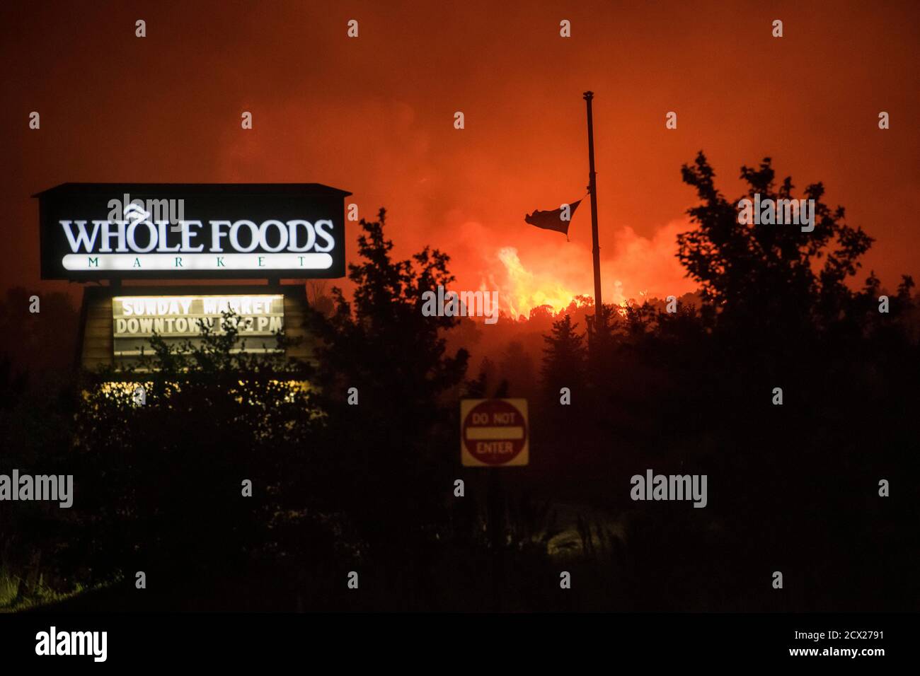 Illuminated sign boards with wildfire in background at night Stock ...