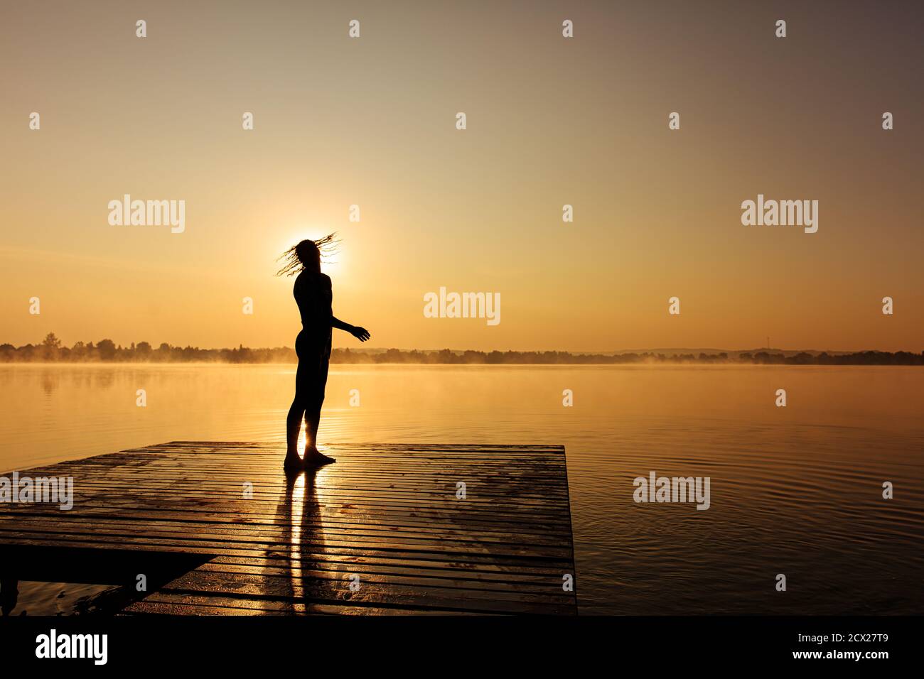 Boy standing on pier by lake hi-res stock photography and images - Alamy