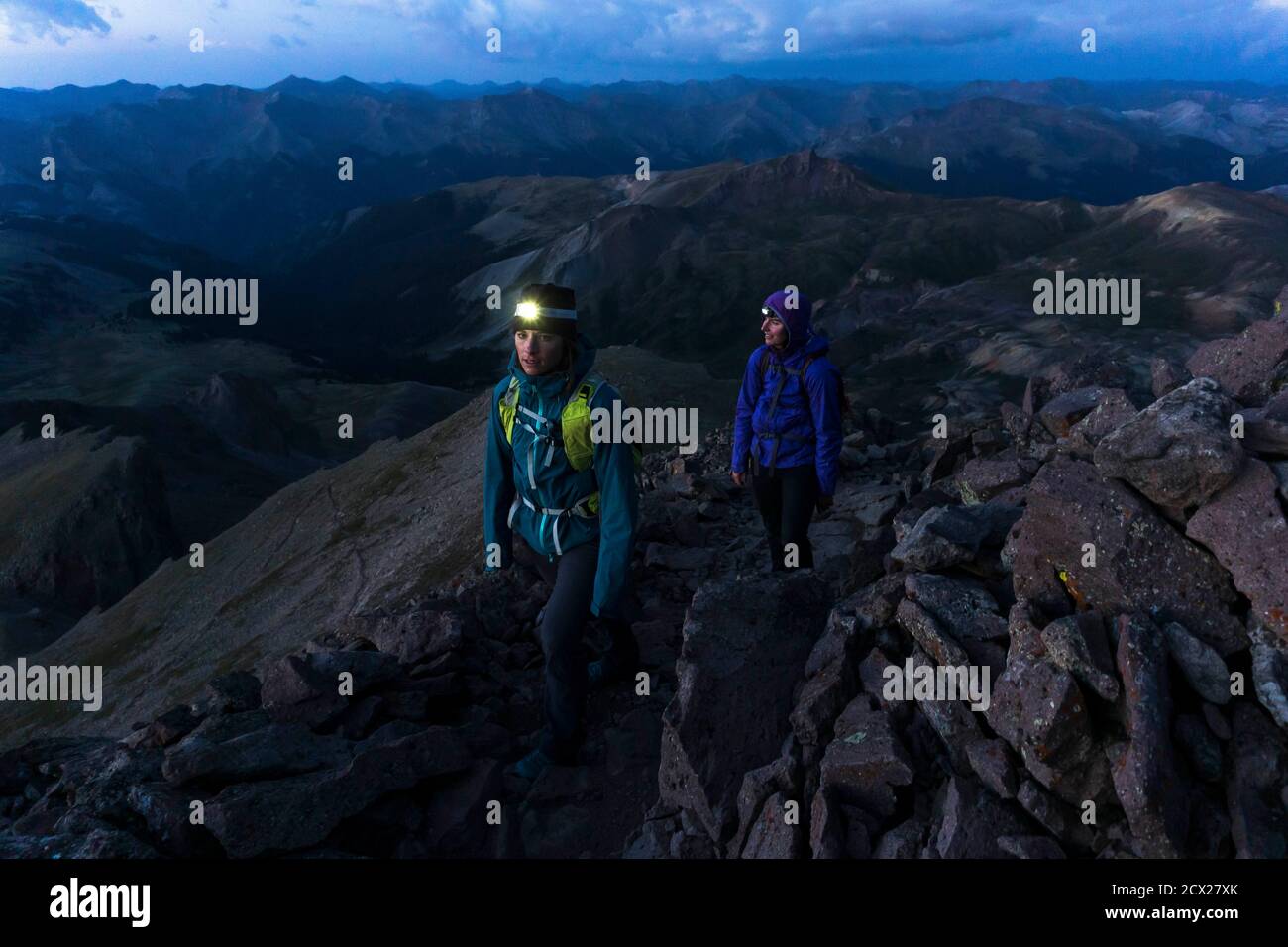 Female hikers on mountain at dusk Stock Photo - Alamy