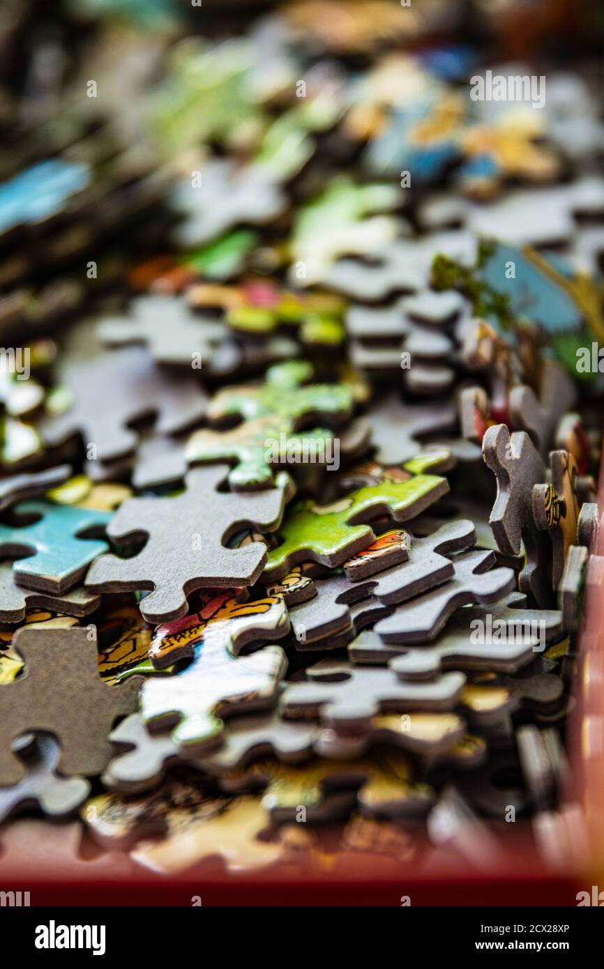 Puzzle pieces in a cardboard box Stock Photo - Alamy