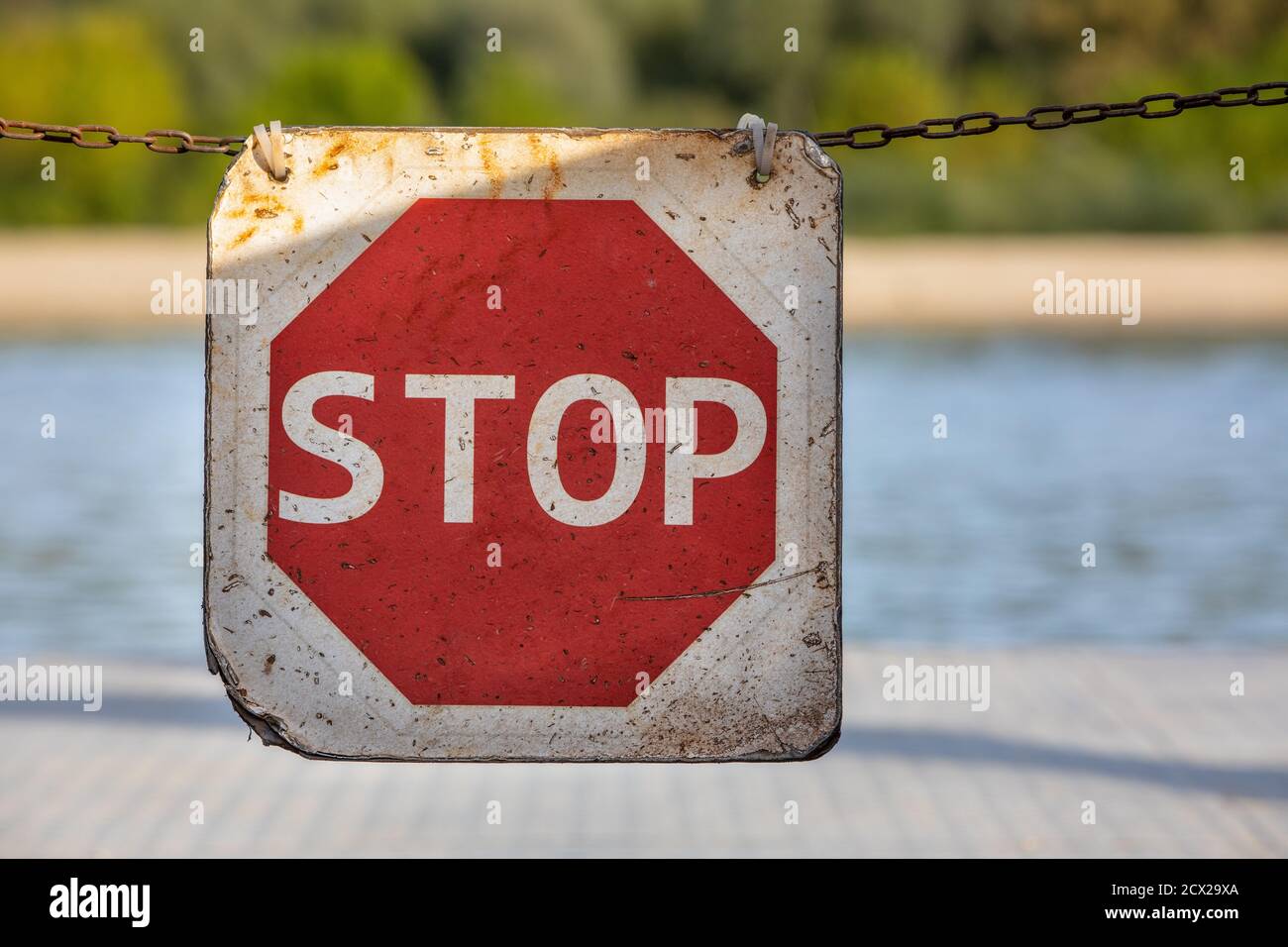 Stop sign on suspended chain. Road sign to warn to stop. Background ...