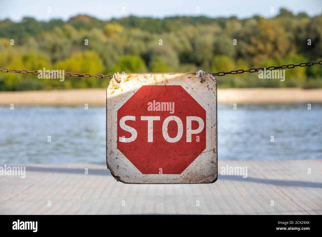 Stop sign on suspended chain. Road sign to warn to stop. Background ...