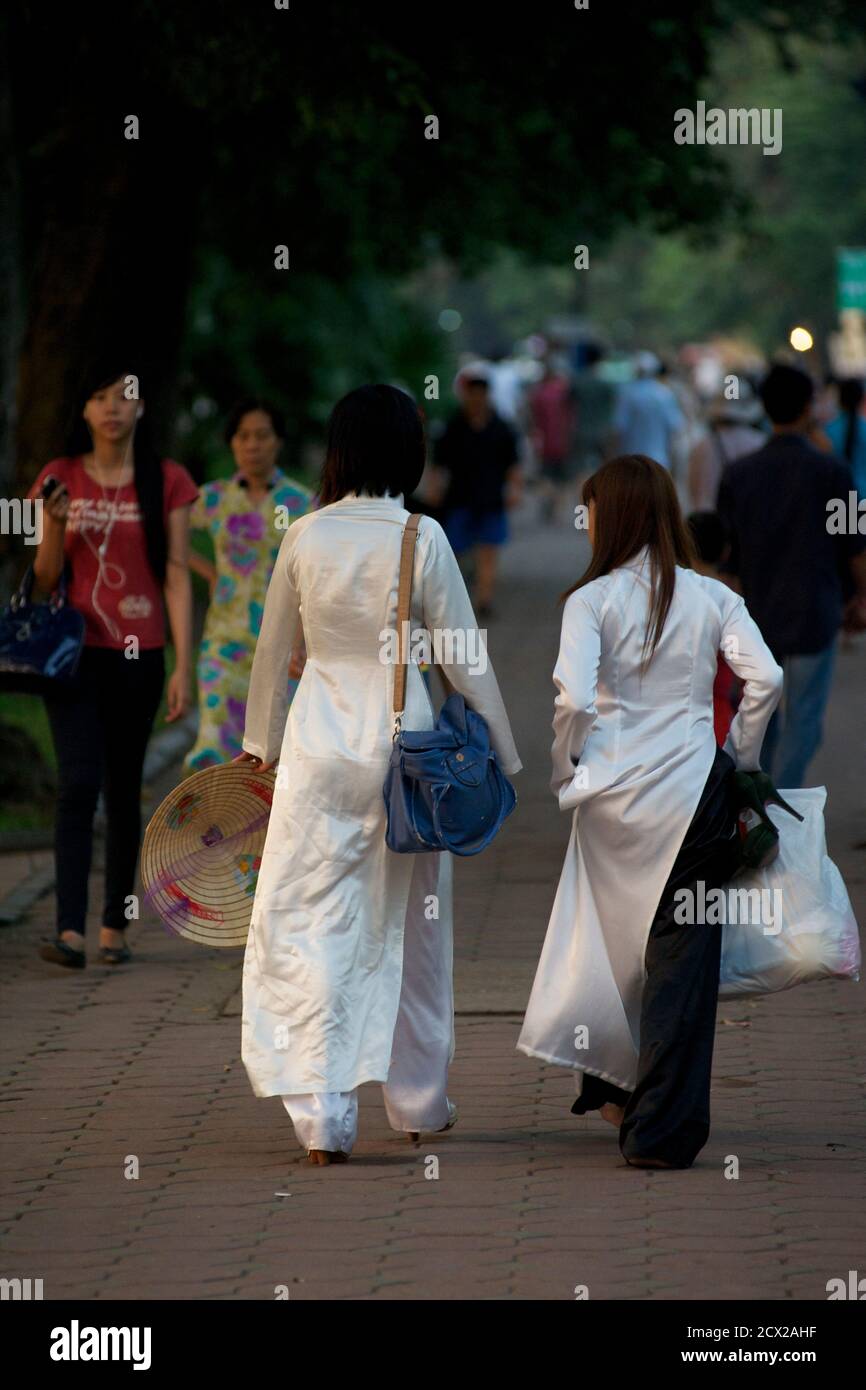 Stylish Vietnamese women in Ao Dai walking beside Hoan Kiem lake, Hanoi ...