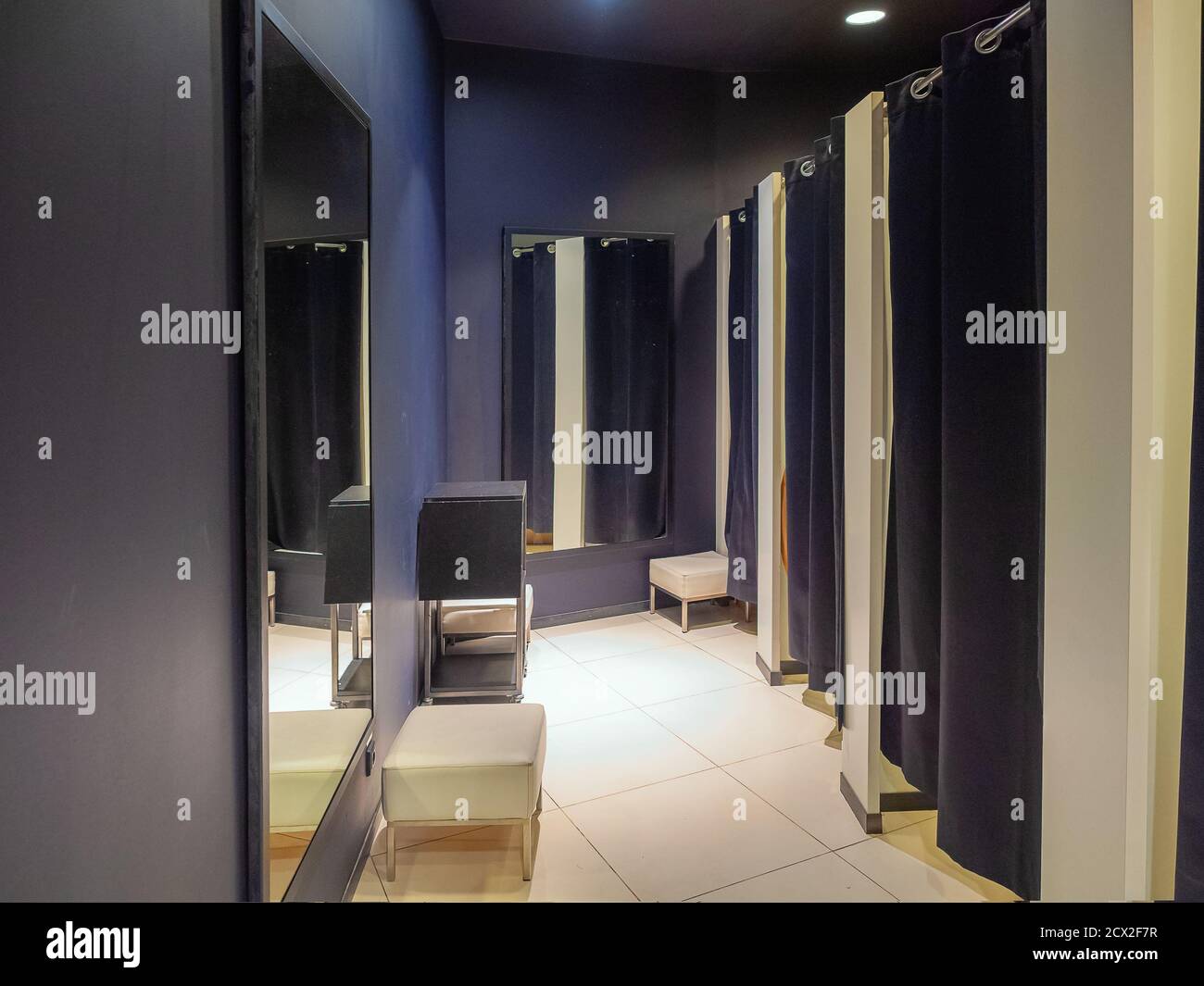 Fitting rooms with blue velvet curtains blue walls and mirrors Stock ...