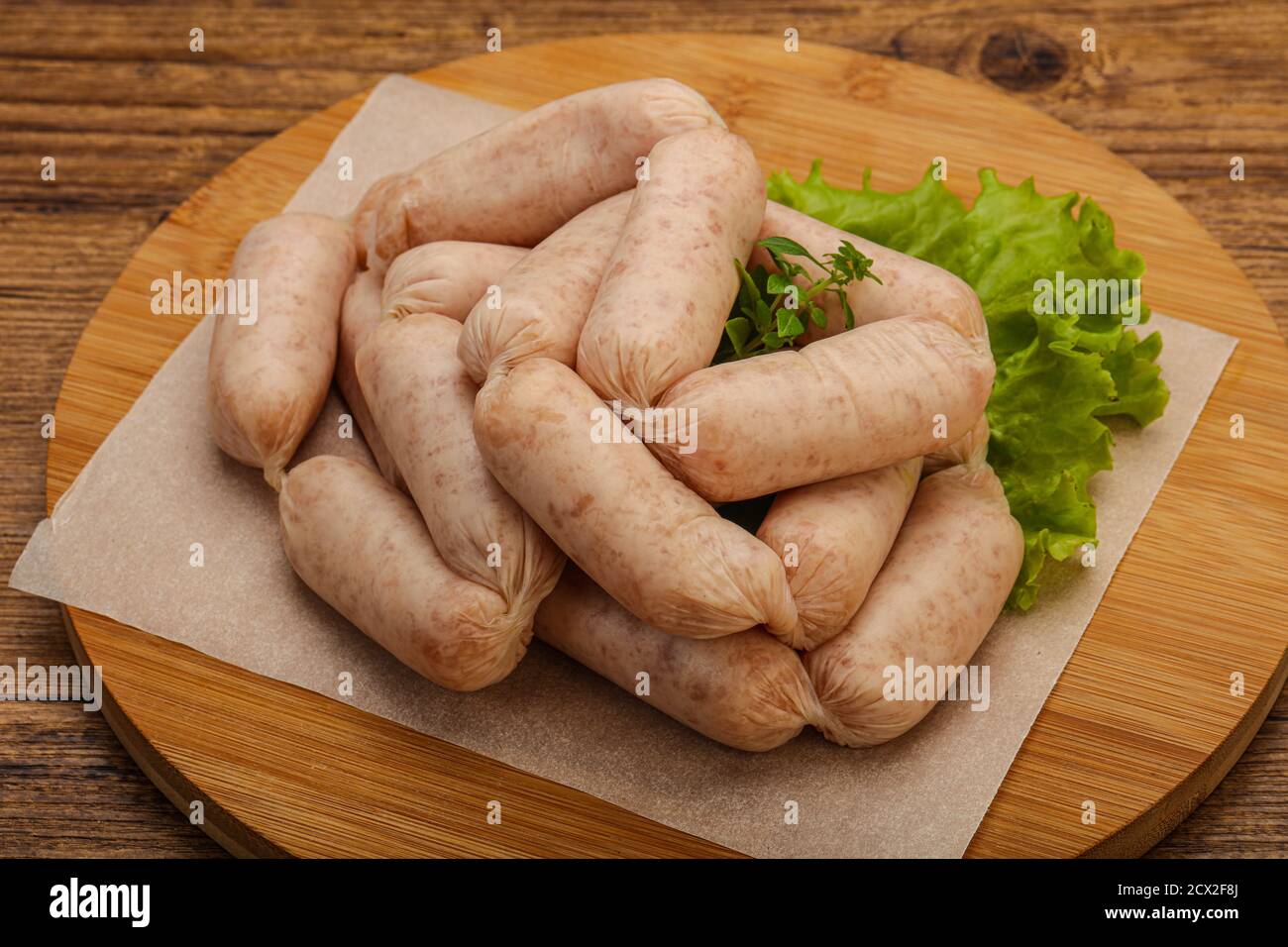 Raw natural chicken baby sausages for roast Stock Photo - Alamy