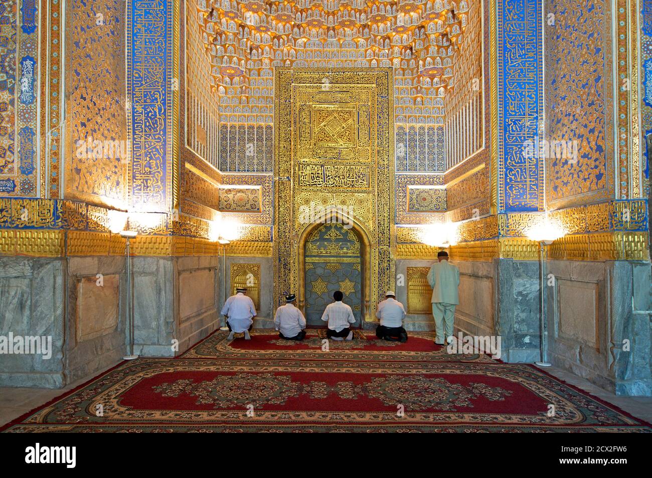 Muslim men praying at the Tilla-Kari Madrassah, Samarkand, Uzbekistan ...
