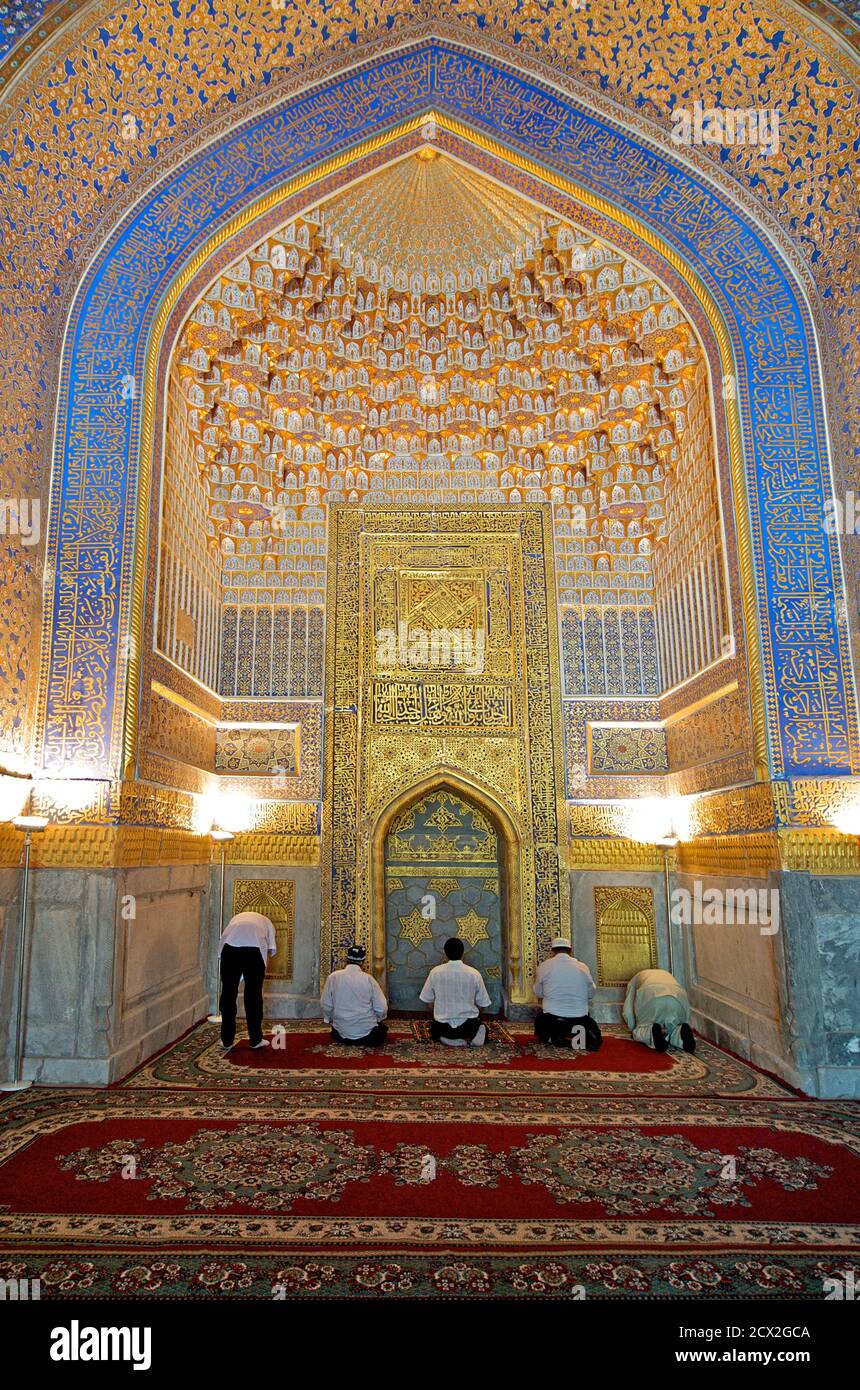 Muslim men praying at the Tilla-Kari Madrassah, Samarkand, Uzbekistan ...