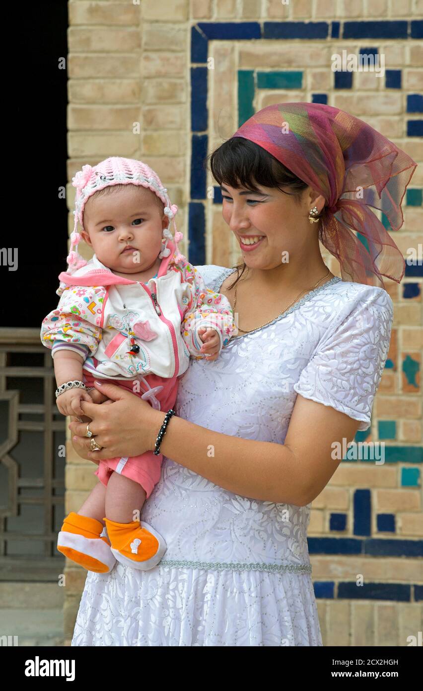 Portrait of an Uzbeki mother and child in the courtyard of the Kalon ...