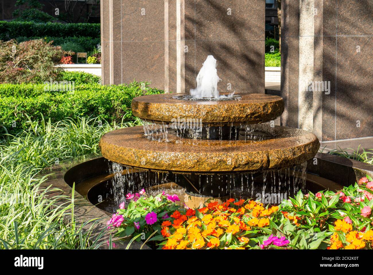 Garden in front of a building with fountain and various plants. Exotic ...