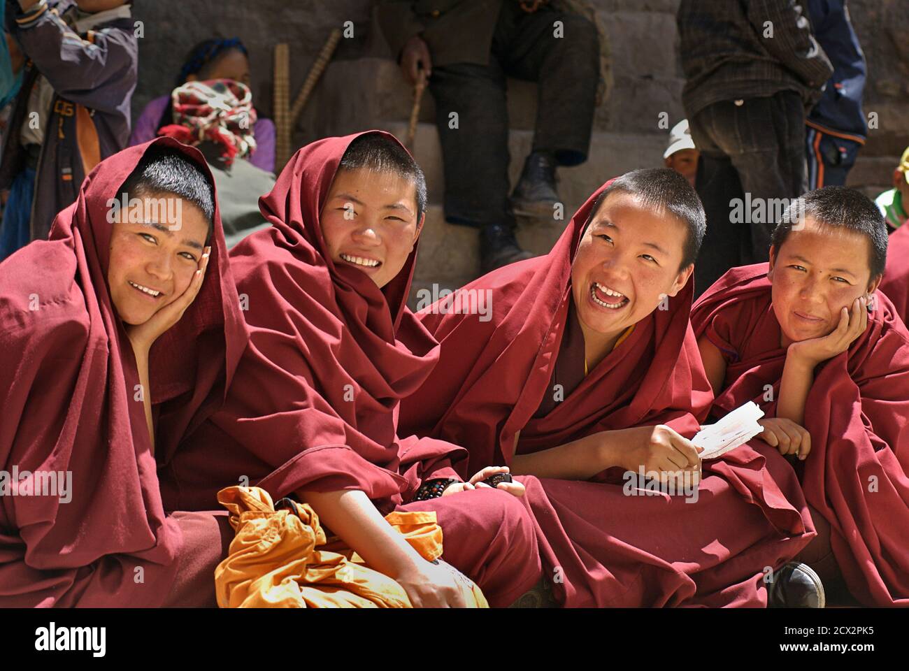 Group of Tibetan nuns in burgundy robes at a festival, Sakya monstery ...