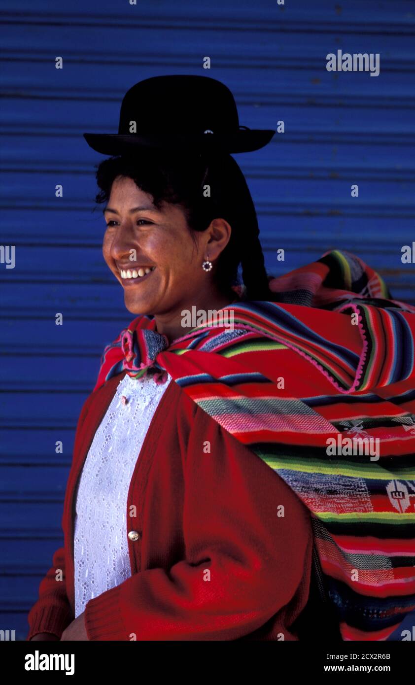 Smiling Quechua woman in distinctive tribal dress, at market, Puno ...