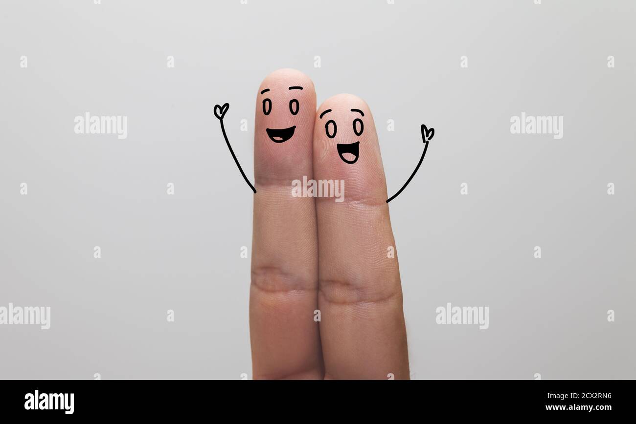 Closeup shot of fingers and facial expressions illustrated on them ...