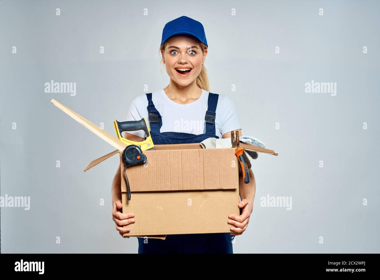 Working woman box with tools courier delivery work Stock Photo - Alamy