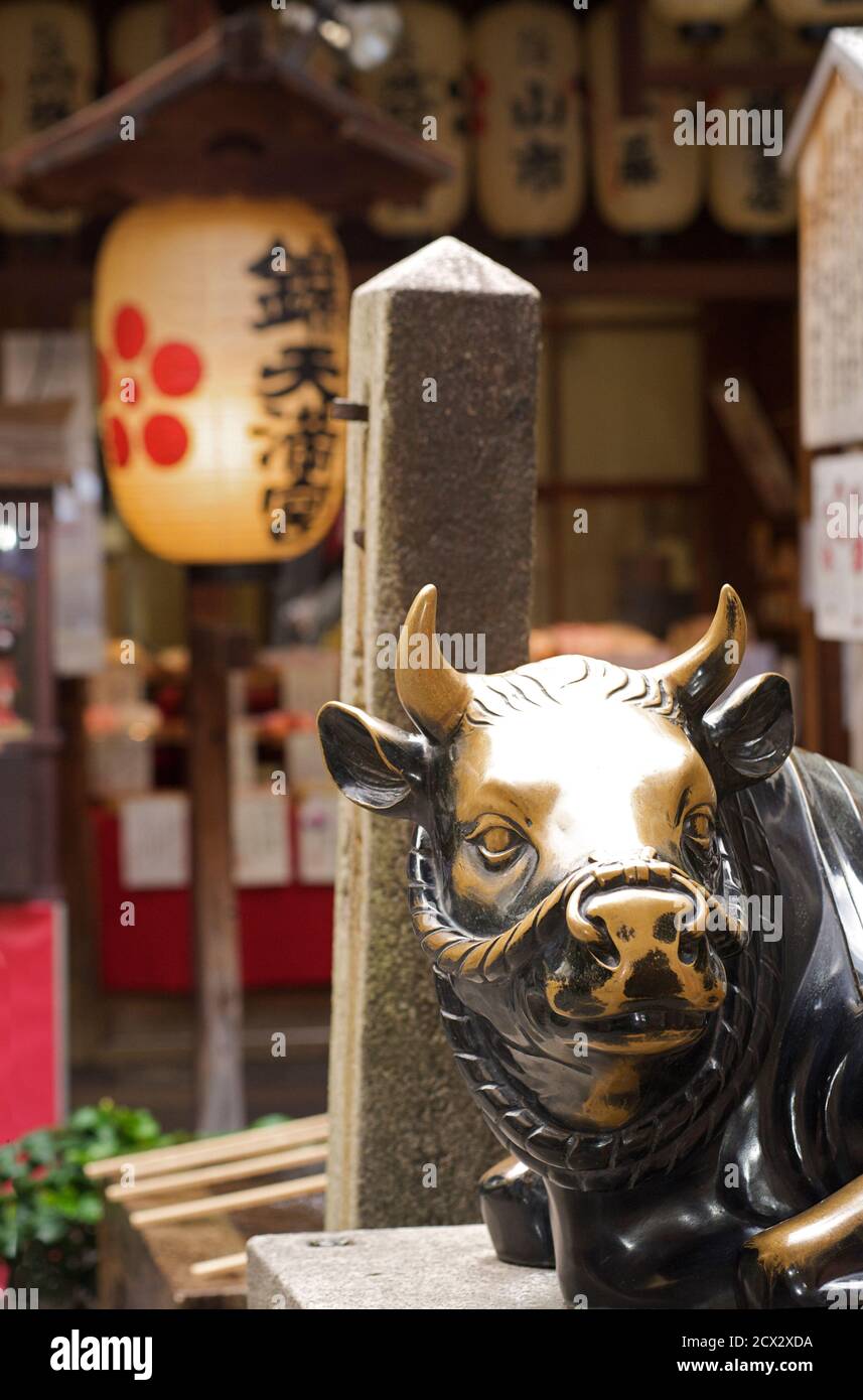 Sculpture of a sitting bull. Nishiki Tenmangu shrine, Kyoto, Japan ...