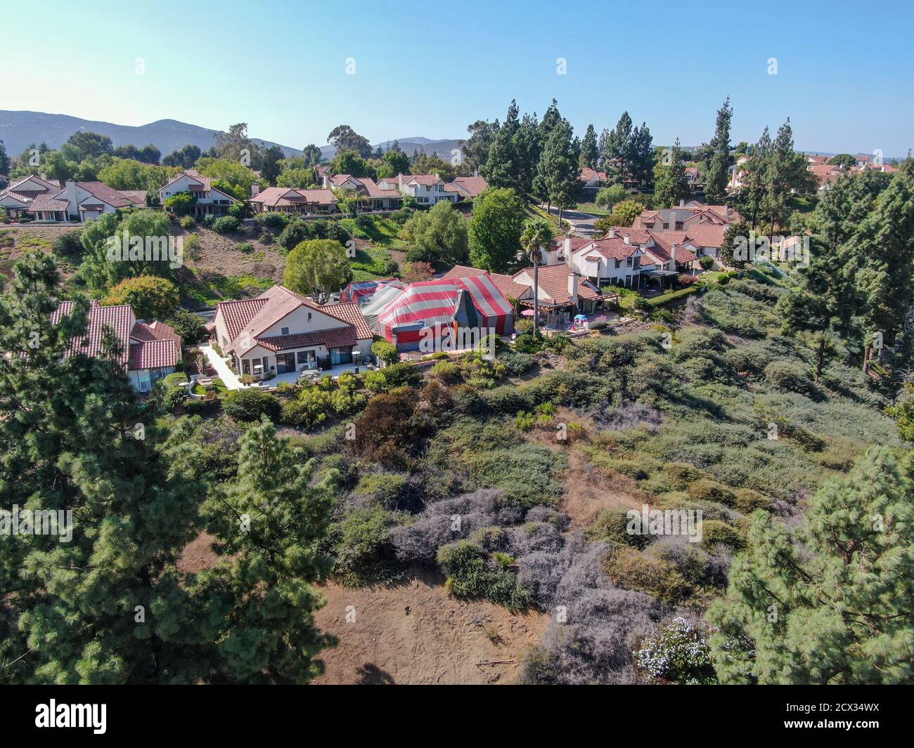 Aerial view of villa covered with a red and green tent while being ...