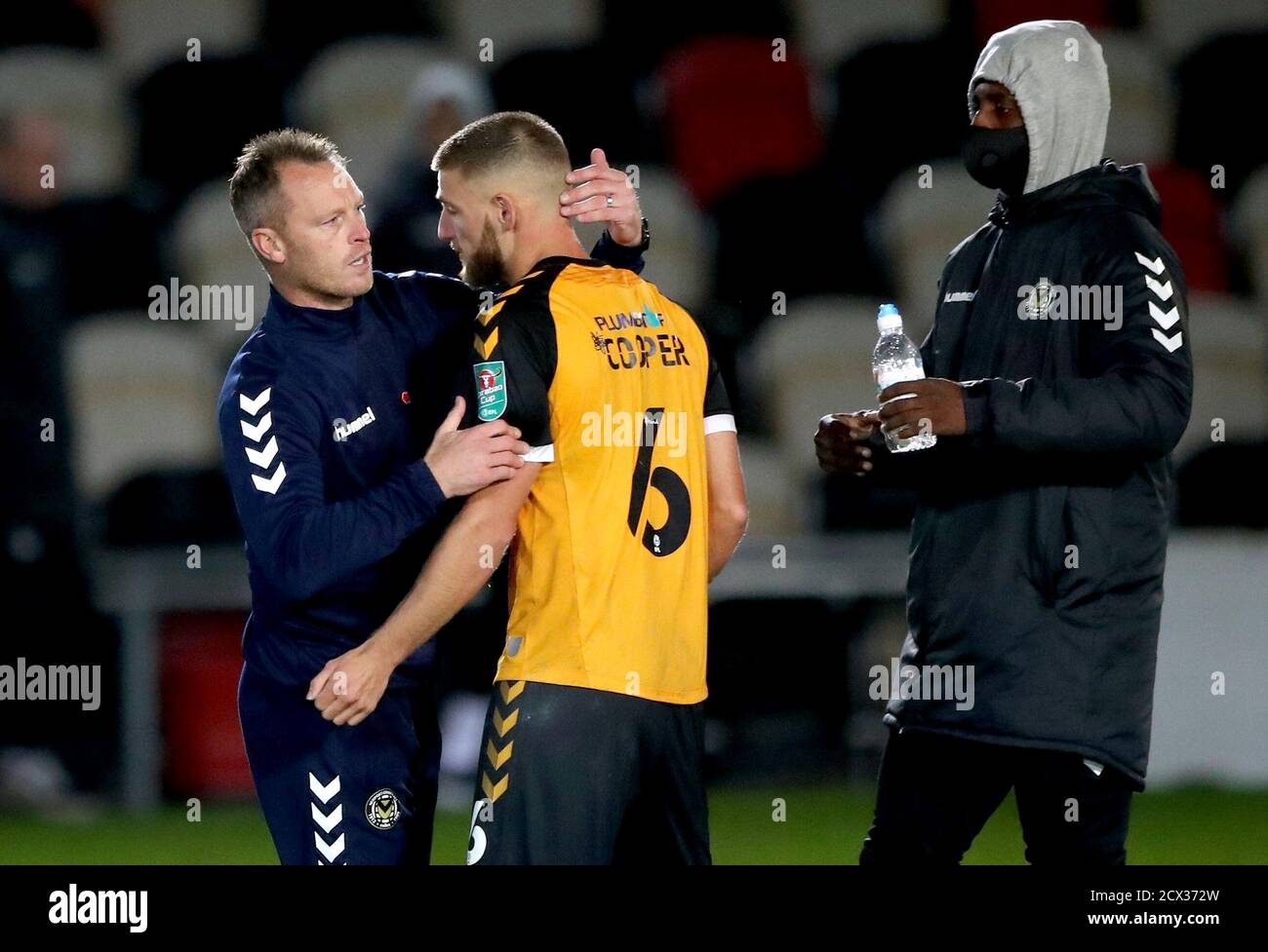 Newport County manager Michael Flynn comforts Brandon Cooper at the end ...