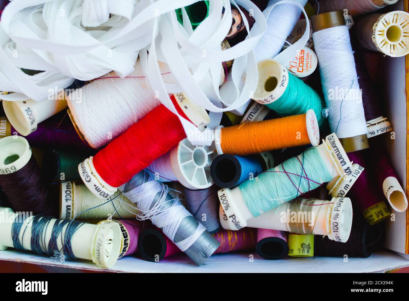 Box with sewing threads disorganized Stock Photo - Alamy