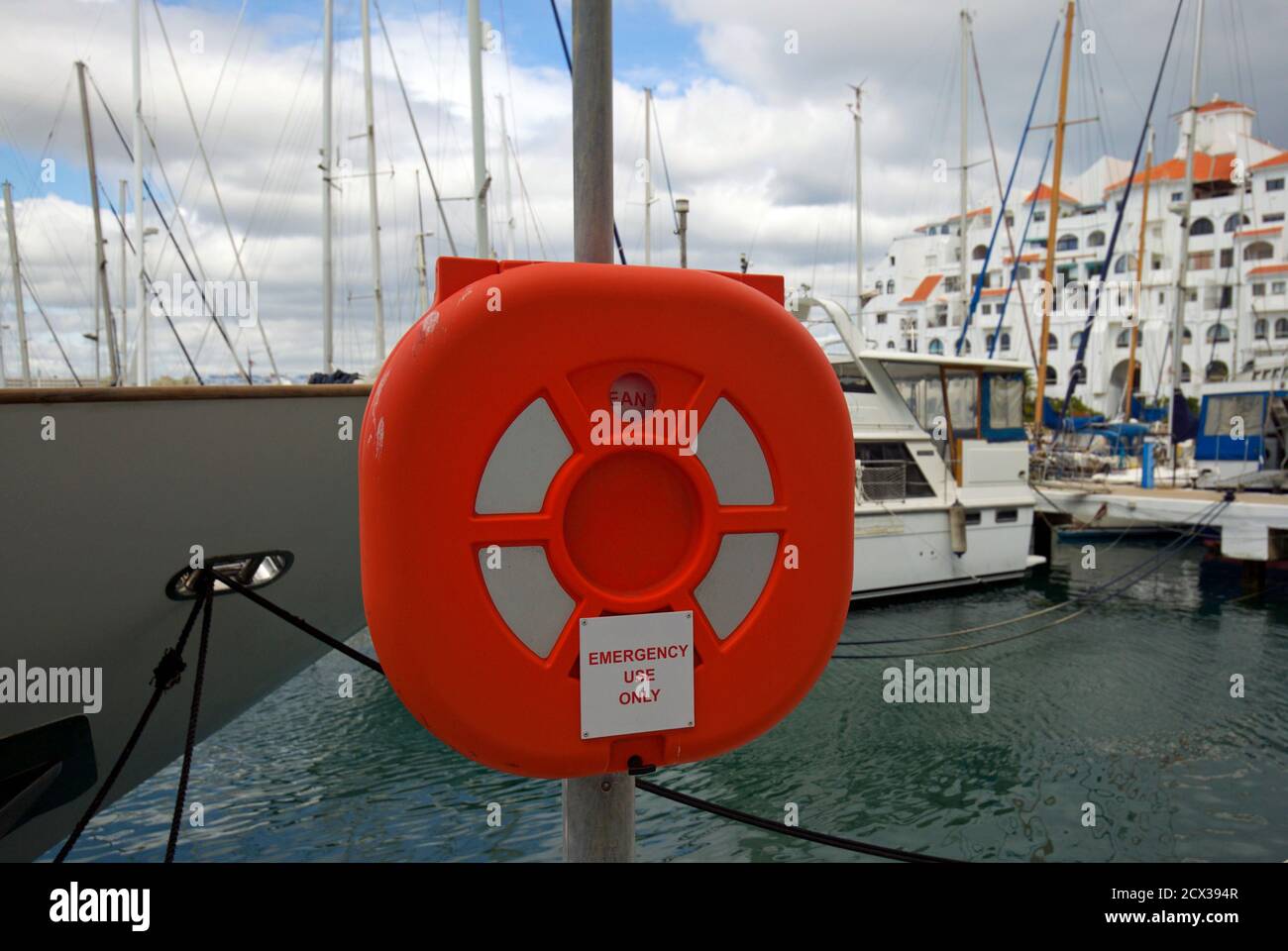 Emergency use Only. A bright orange Lifebuoy and housing placed on a ...