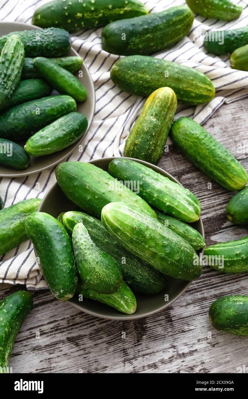 Top view fresh farm cucumbers on wooden background. Rustic style ...