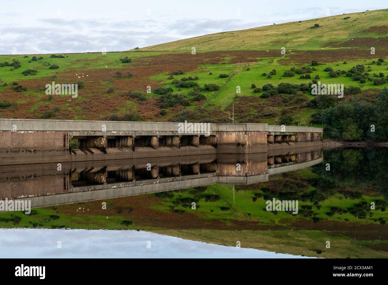Meldon Dam and hillside reflected in reservoir Stock Photo - Alamy