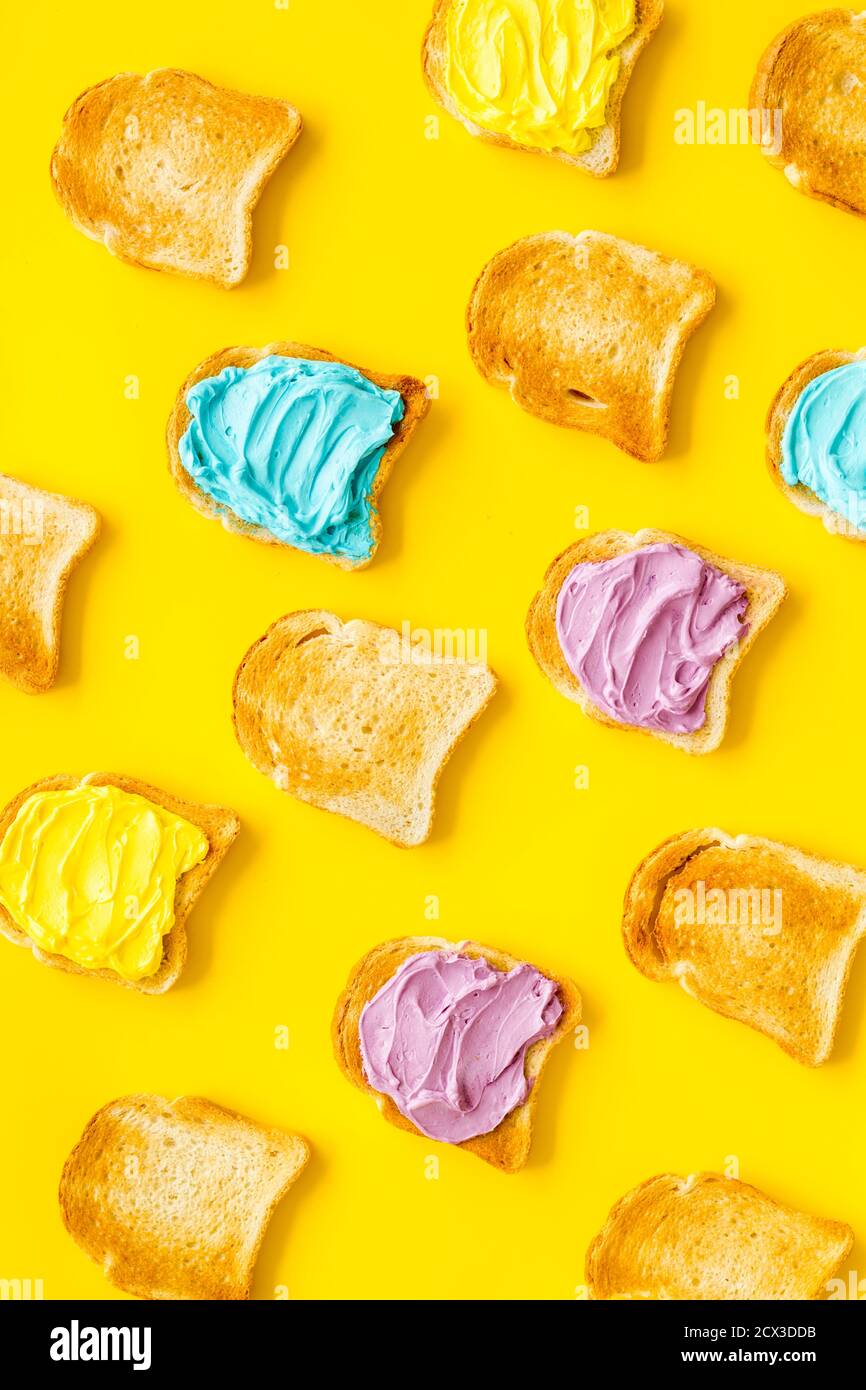 Pattern of toast bread with colored cheese spread. Layout top view ...