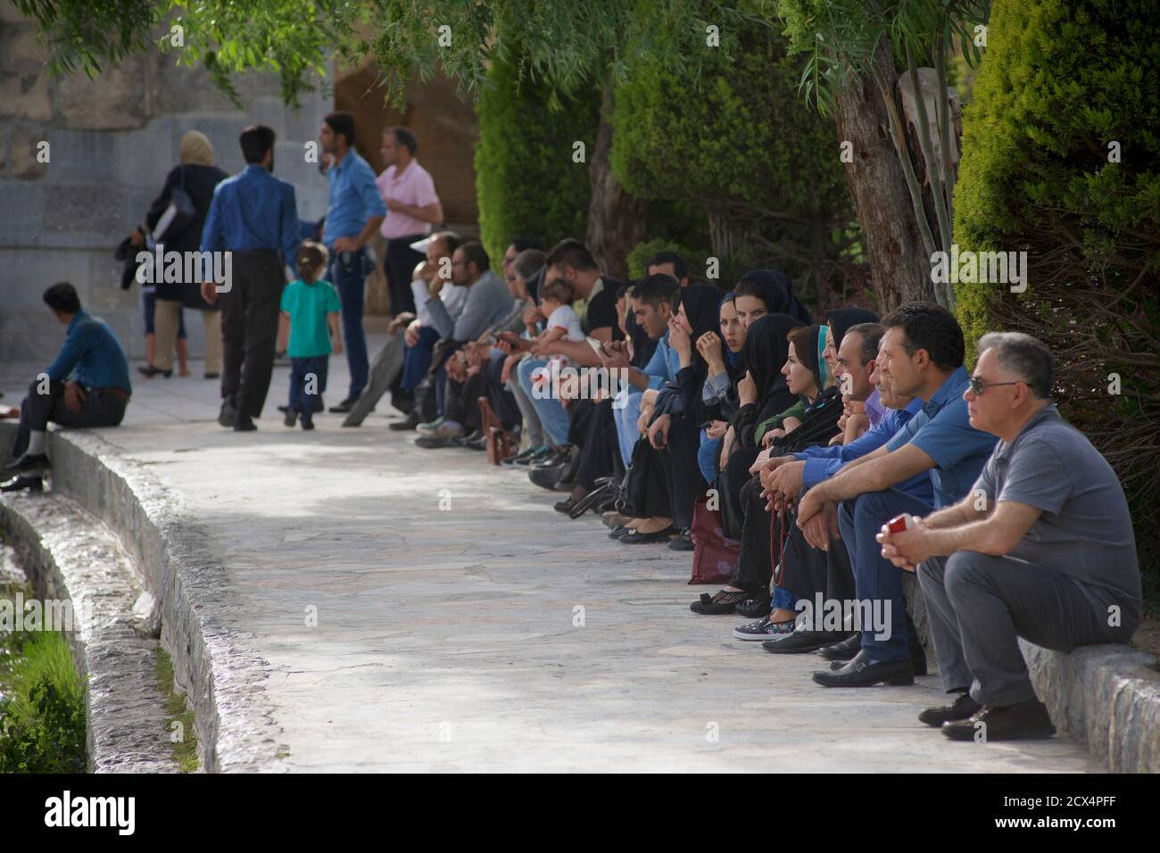 Iranians sitting on the riverbank, Isfahan, Iran Stock Photo - Alamy