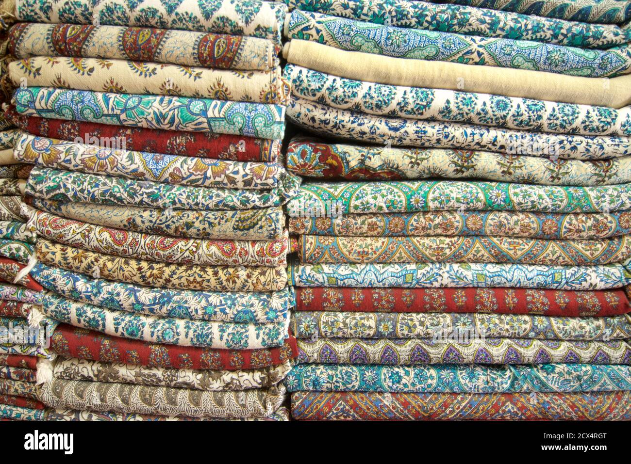 Stack of folded fabrics for sale at market, Isfahan Iran Stock Photo ...