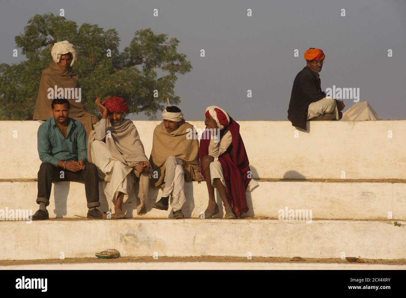 Rajasthani men sitting talking on the stadium steps. Pushkar, Rajasthan ...
