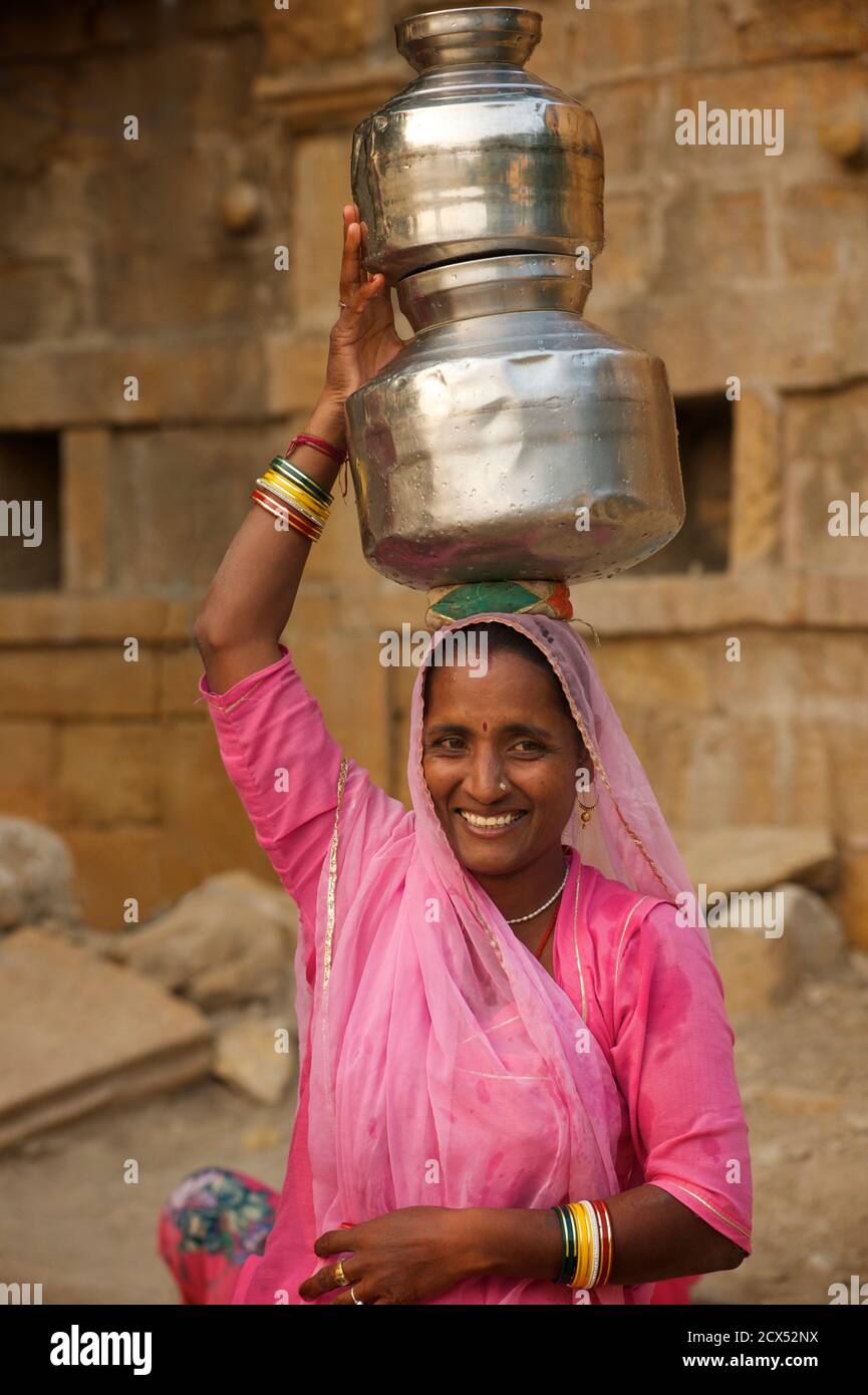 Rajasthani woman collecting water from a well at Amar Sagar, Lodurva ...