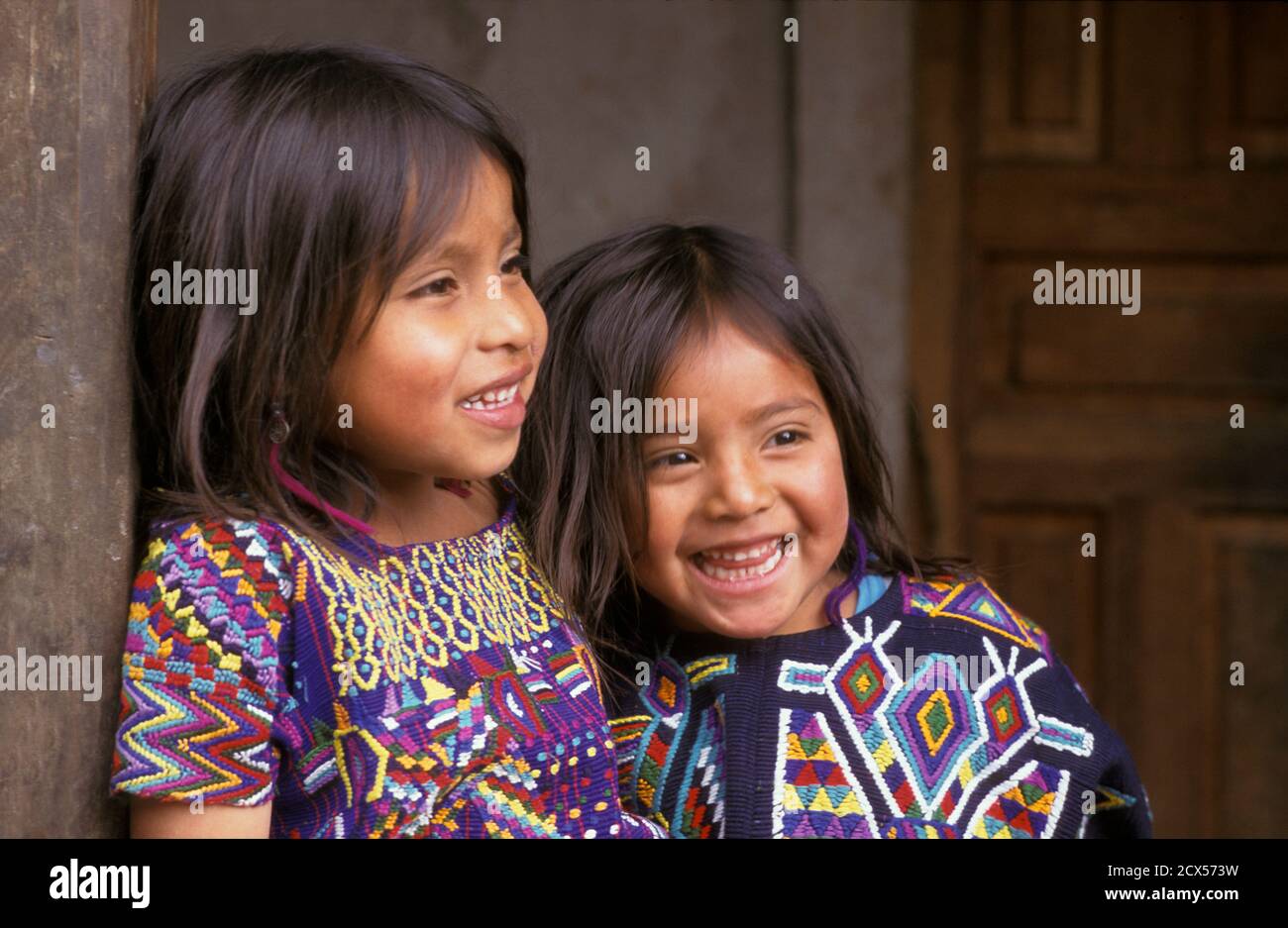 Ixil Maya sisters wearing the brocaded typical dress of their community ...