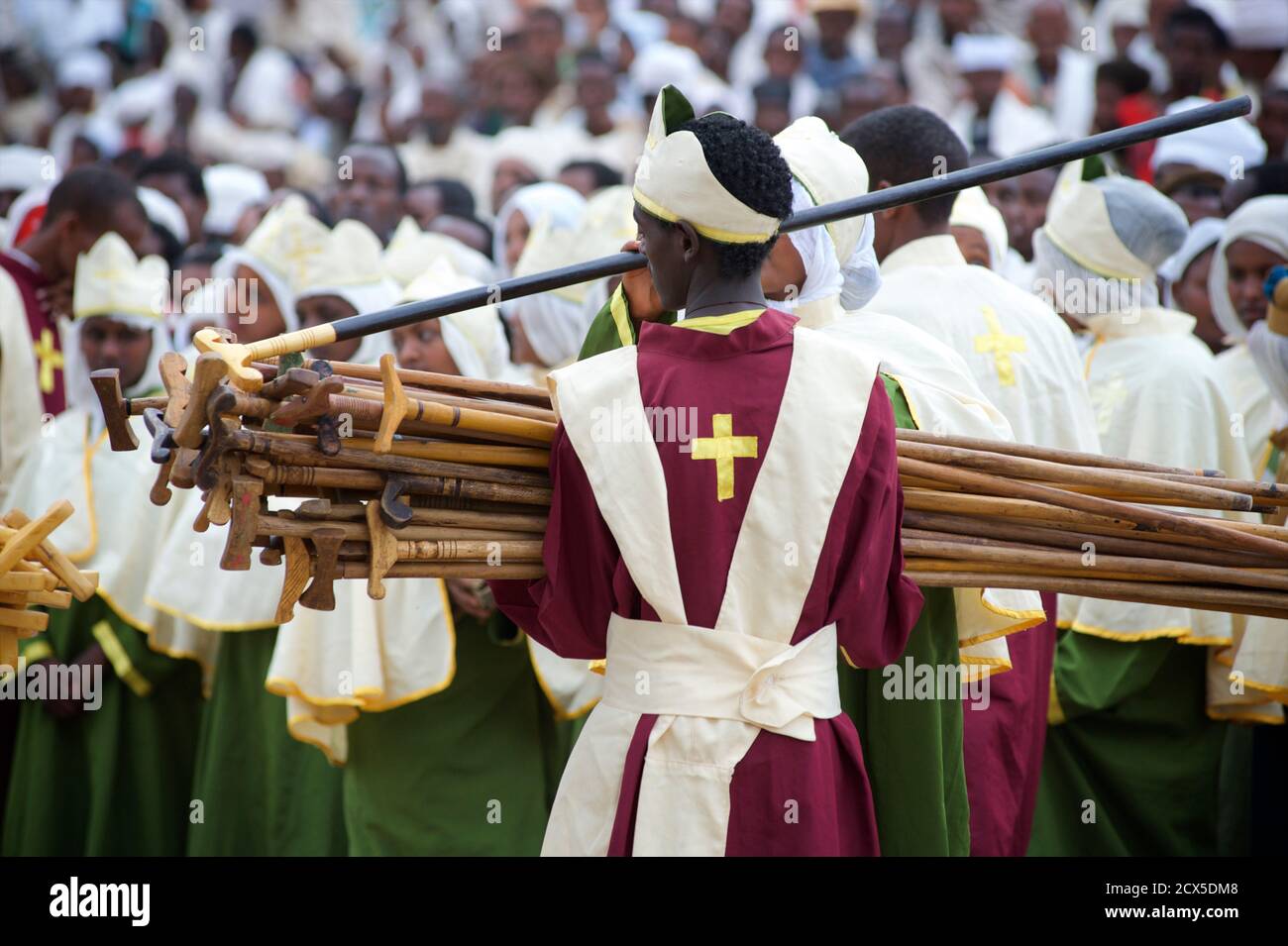 Religious helper carrying prayer staffs at a ceremonial event for Palm ...