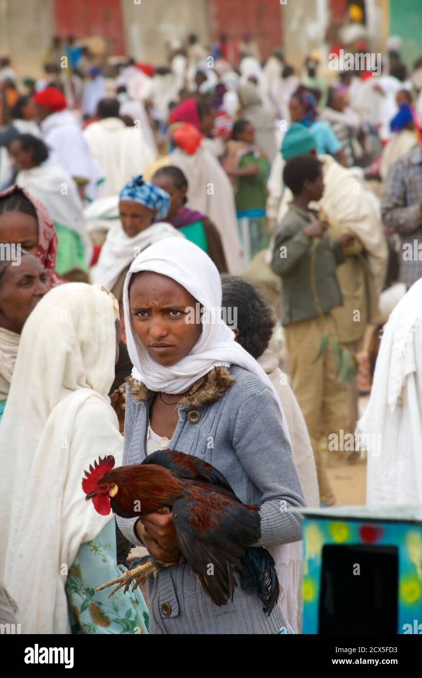 Ethiopian woman with chicken. Market day at Freweyni also known as ...