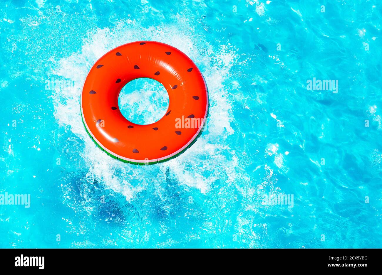 Inflatable red watermelon with seeds buoy splash fall into the swimming ...