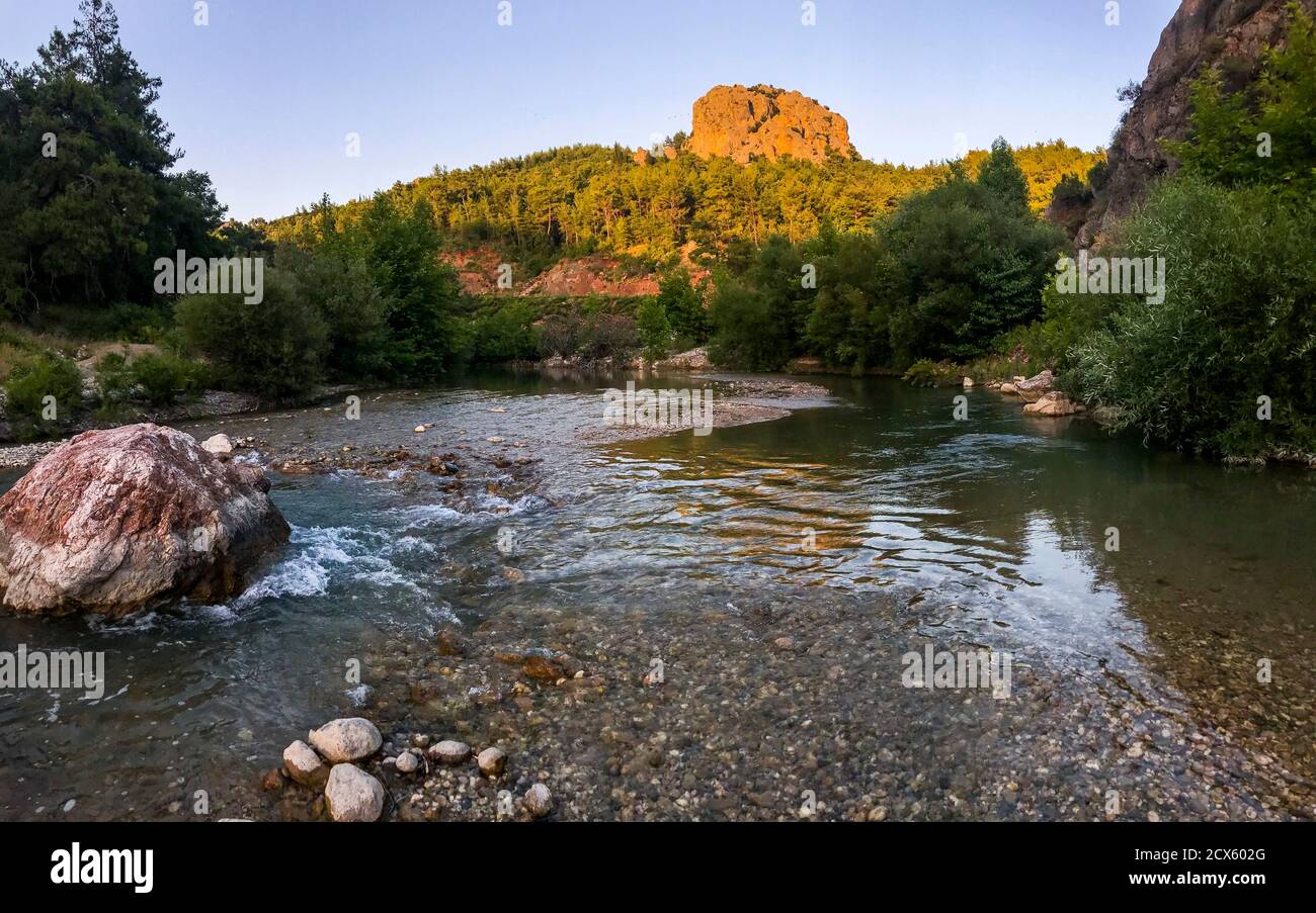 River and forest flowing from Mountain foothills Stock Photo - Alamy