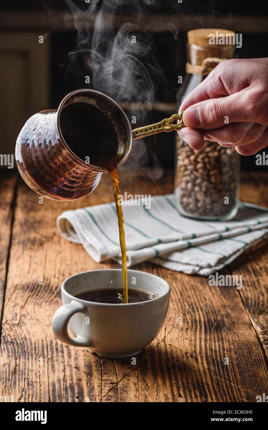 Pouring turkish coffee into white cup Stock Photo - Alamy