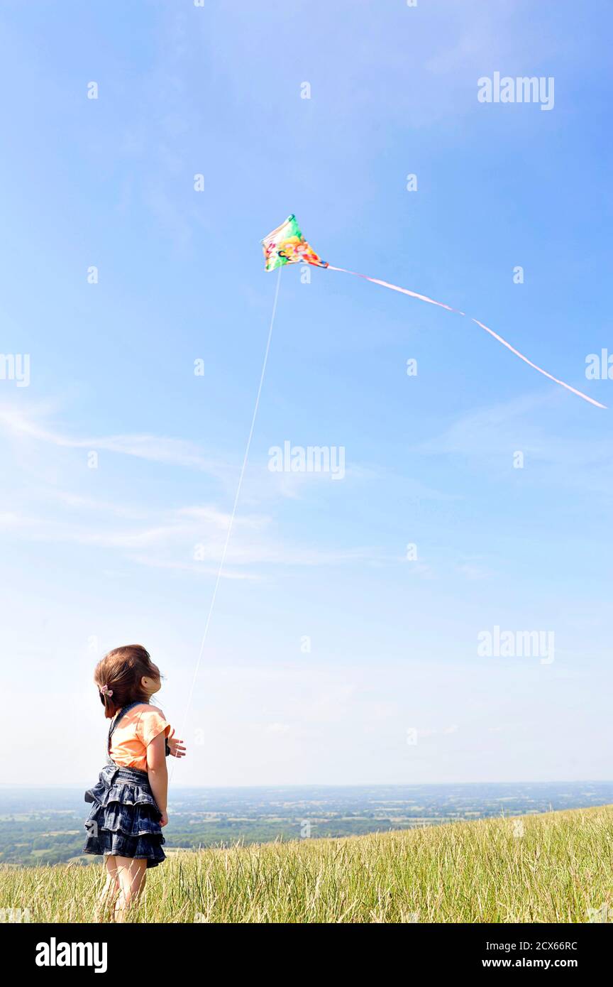 Girl flying a kite in the English countryside Stock Photo - Alamy