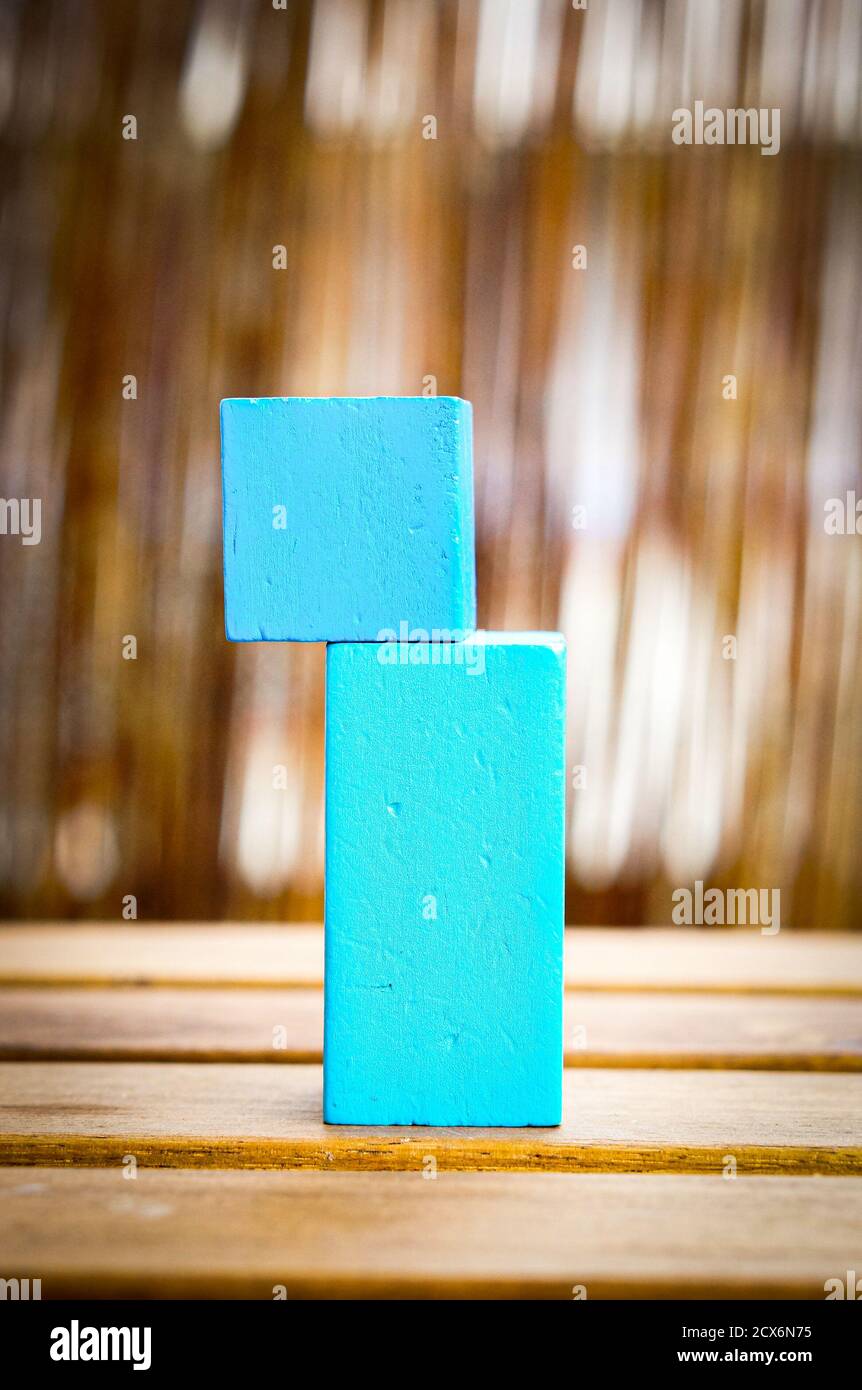Vertical shot of blue cubes on a wooden surface Stock Photo - Alamy