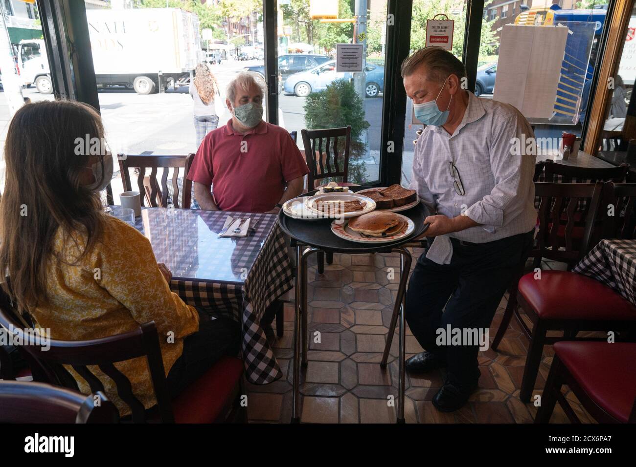 New York, New York, USA. 30th Sep, 2020. A waiter serves lunch to a ...