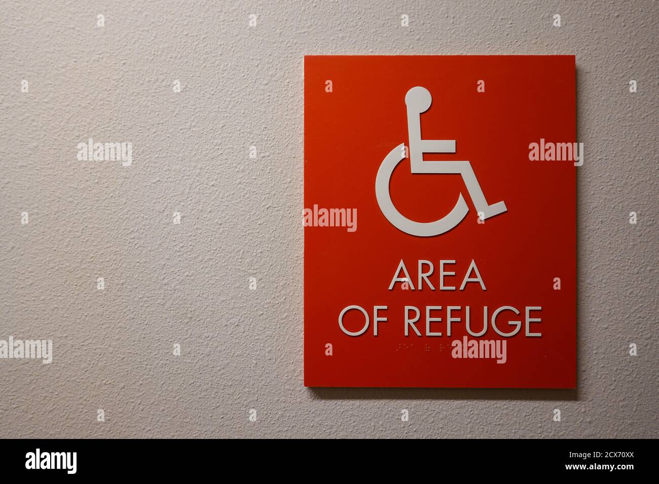 A sign in a hallway in an apartment complex that says Area of Refuge ...