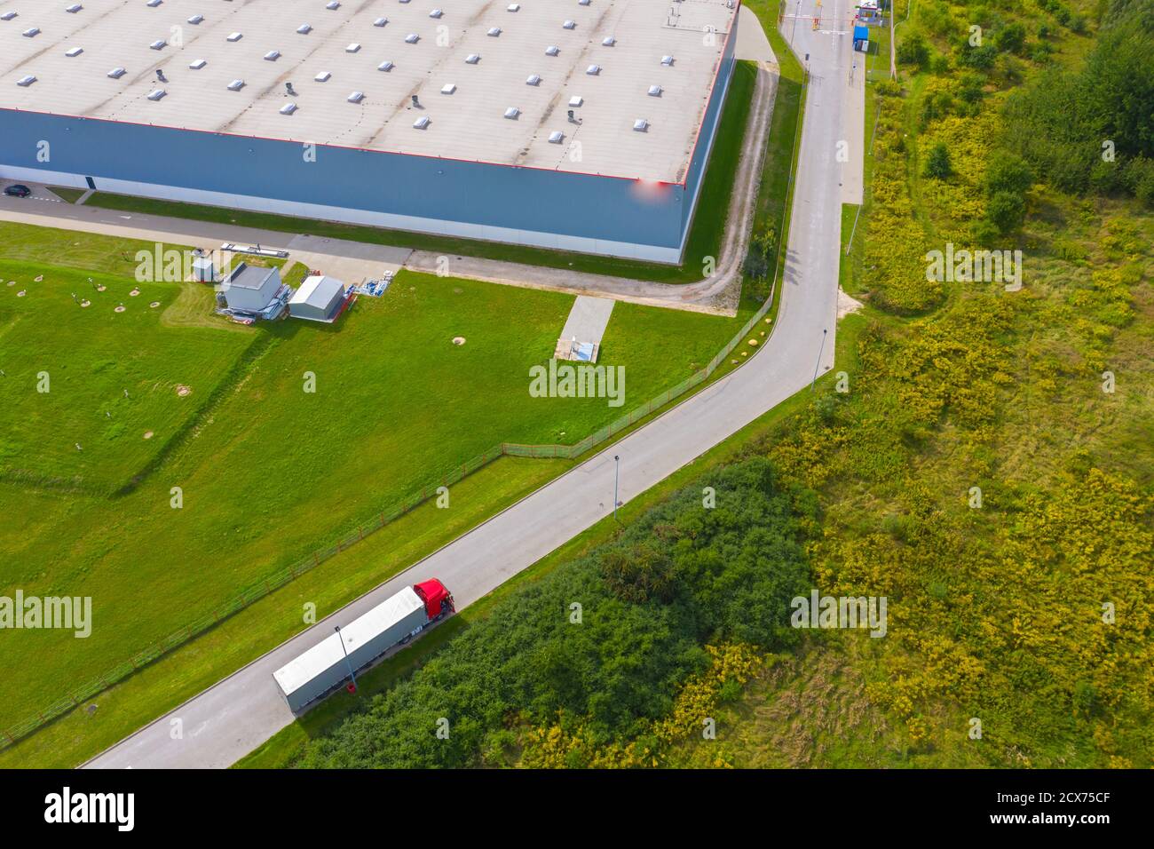 Aerial view of warehouse with trucks driving to the logistic center ...