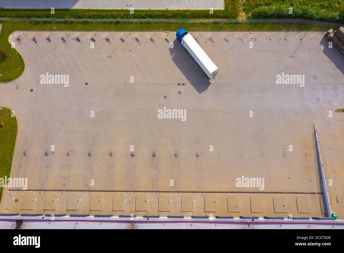 Aerial view of warehouse with trucks. Industrial background. Logistics ...