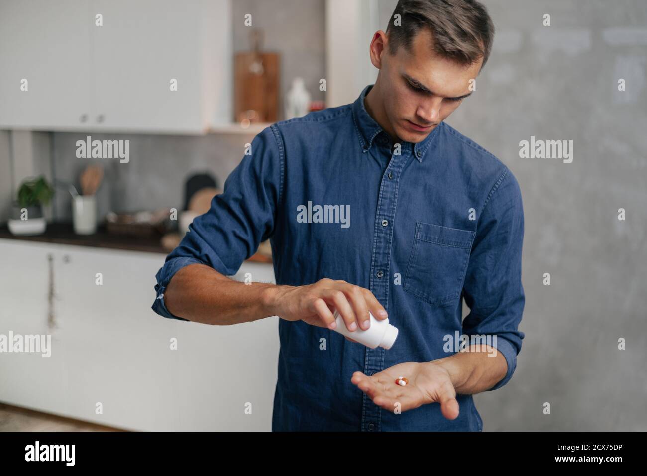 Young men taking medical pill hi-res stock photography and images - Alamy
