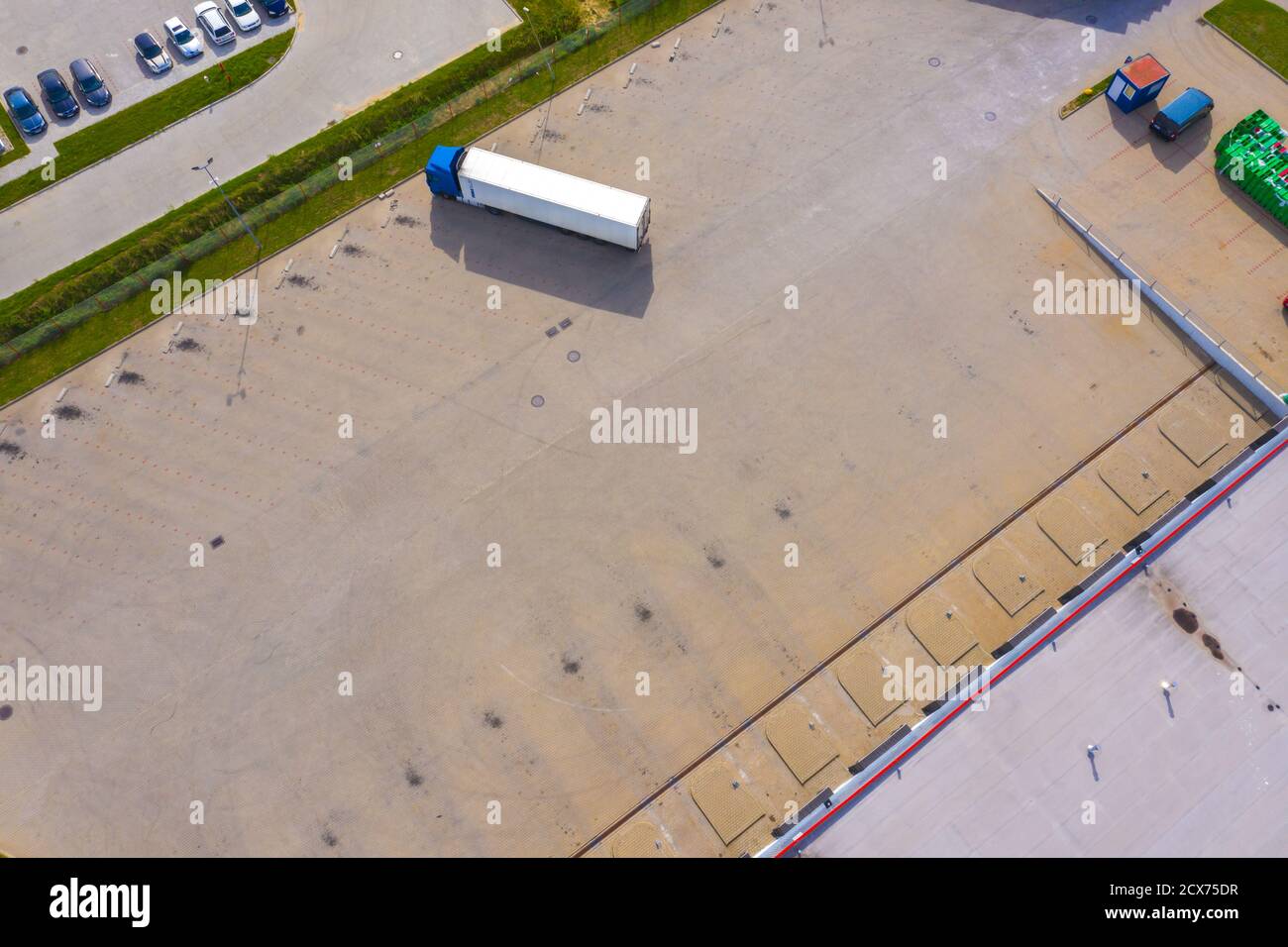 Aerial view of warehouse with trucks. Industrial background. Logistics ...
