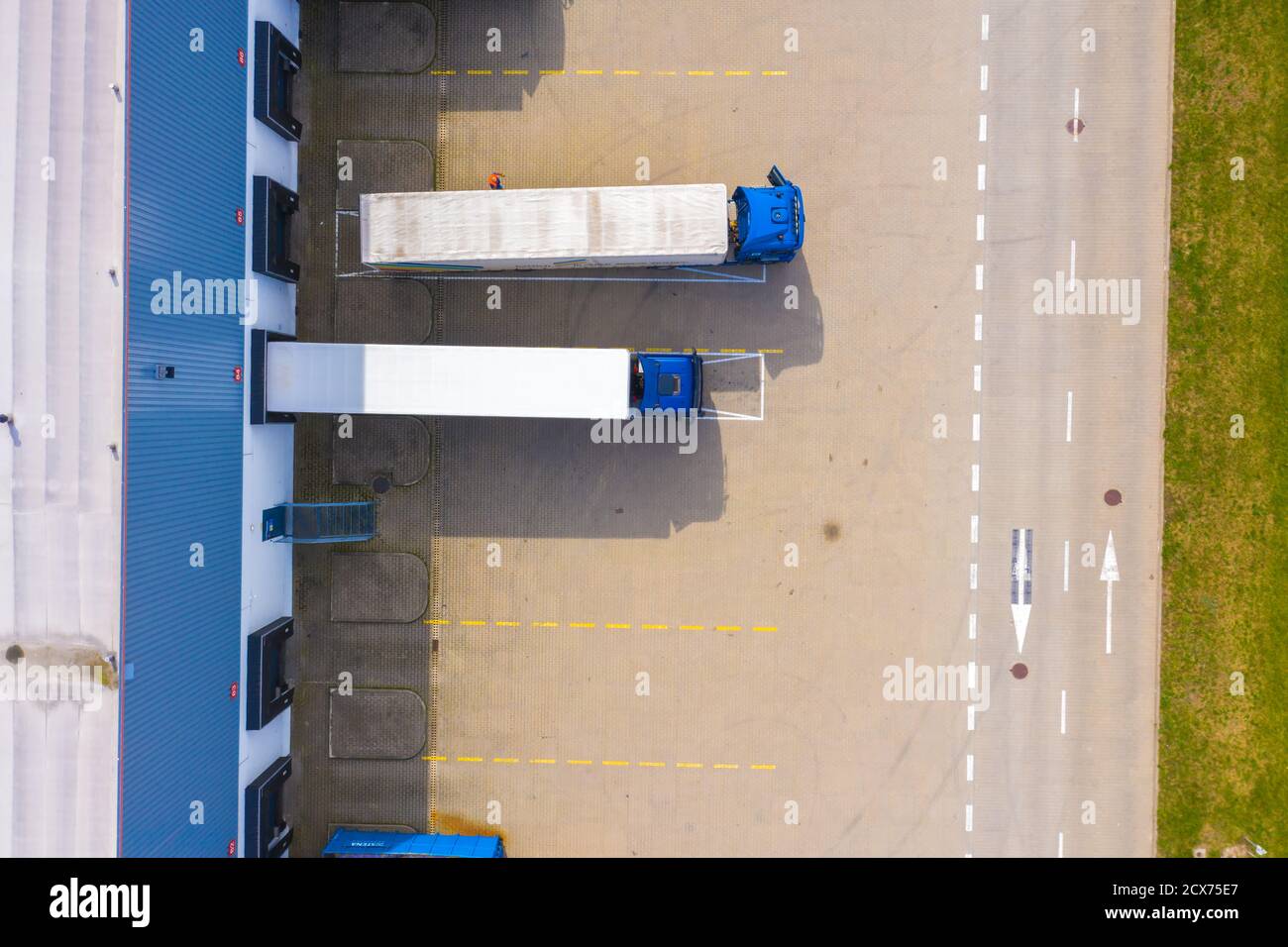 Aerial view of warehouse with trucks. Industrial background. Logistics ...