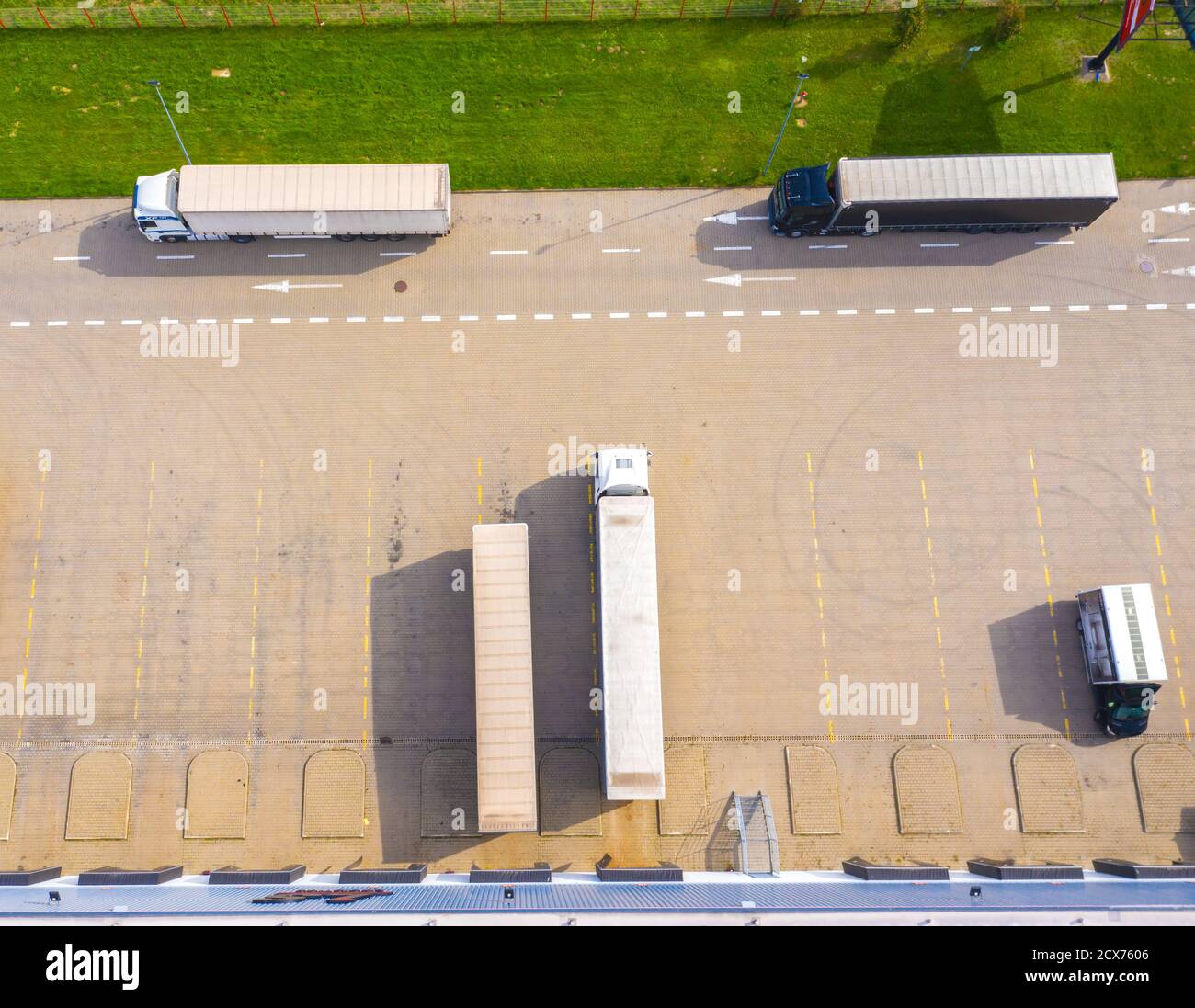 Aerial view of warehouse with trucks. Industrial background. Logistics ...