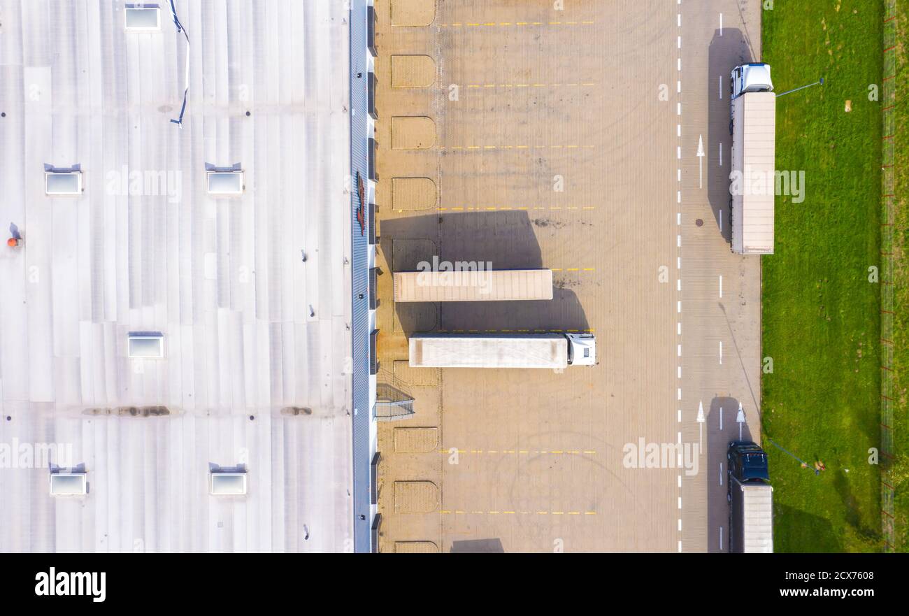 Aerial view of warehouse with trucks. Industrial background. Logistics ...
